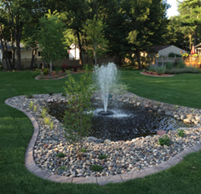 Pond riprap with fountain • Lakeshore Guys® - MN Shoreline Experts